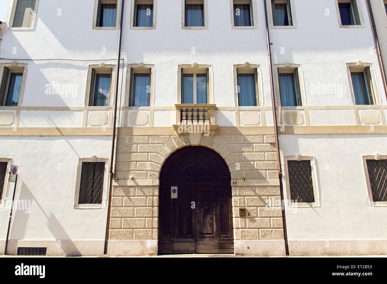 classic Italian building with retro windows and big door. Vicenza city ...