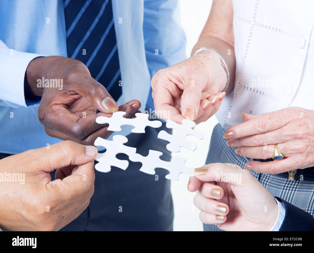 Group of Business People Building Jigsaw Stock Photo - Alamy