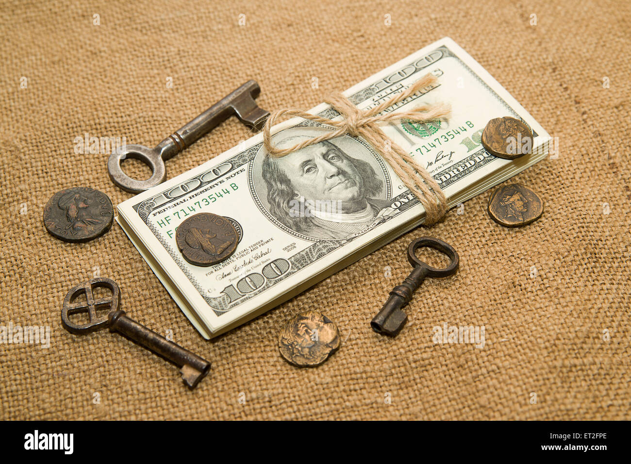 One pack of dollars tied up with rope, coins and keys in the old cloth ...