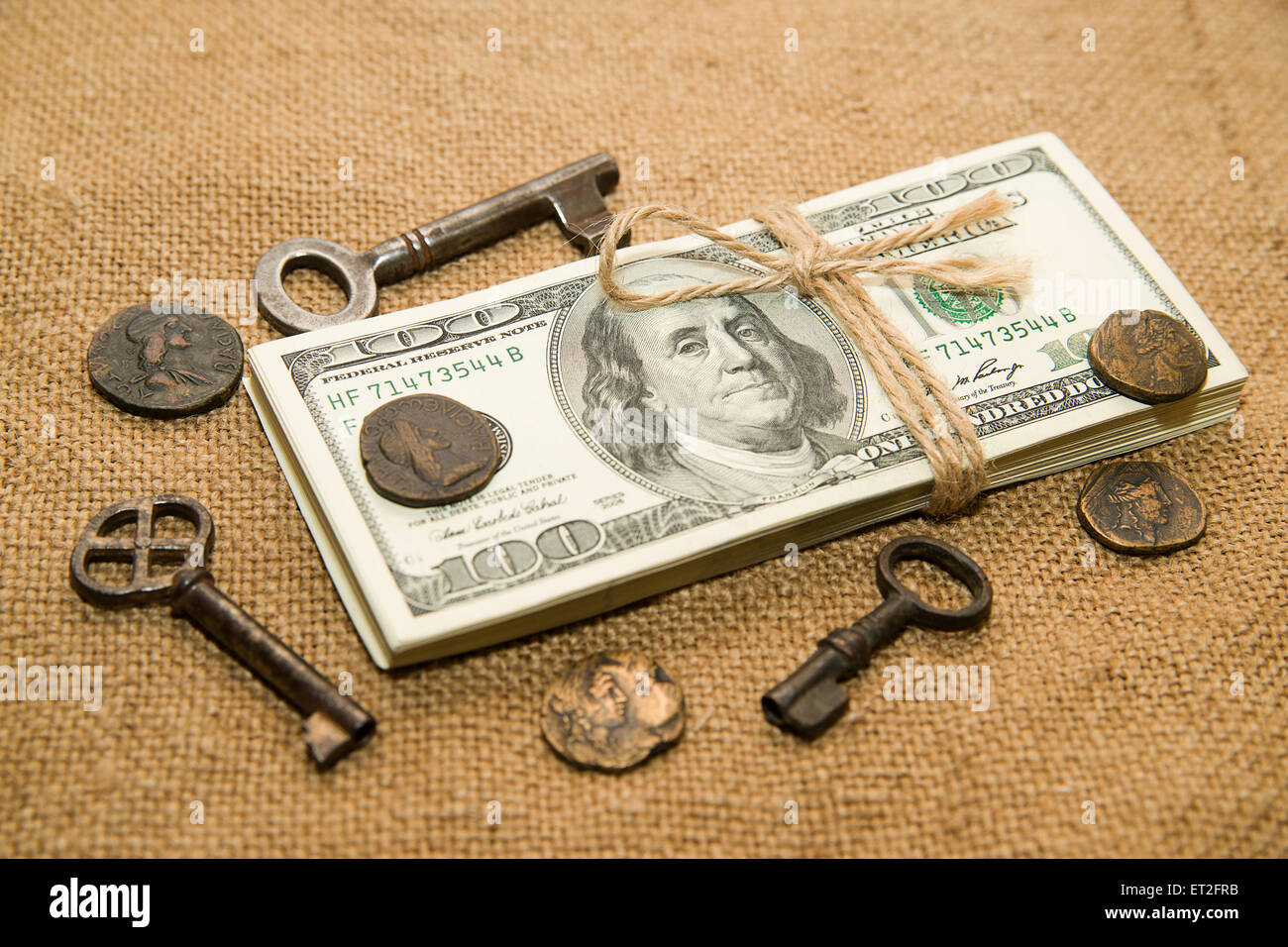 One pack of dollars tied up with rope, coins and keys in the old cloth ...
