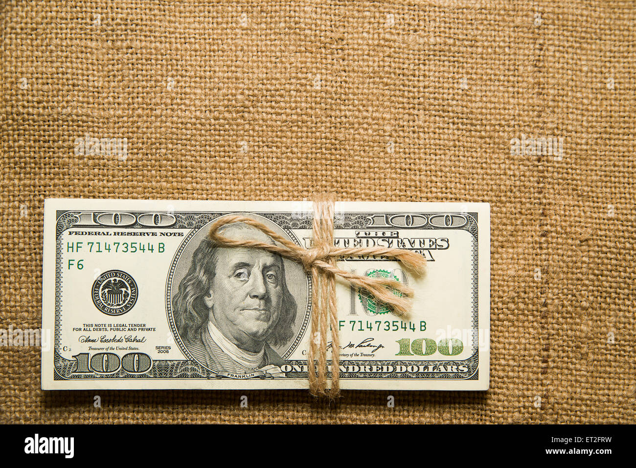 One pack of dollars tied up with rope in the old cloth Stock Photo - Alamy