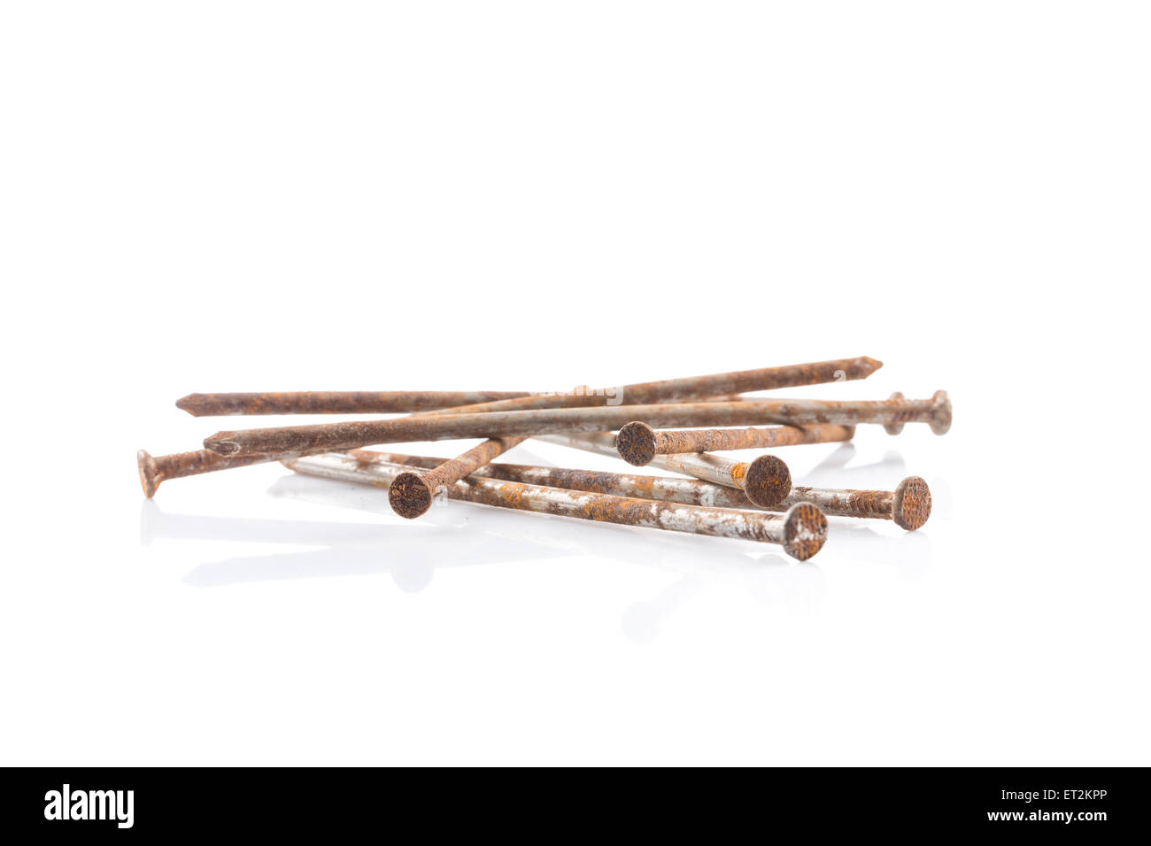 some old rusty nails on white table Stock Photo - Alamy