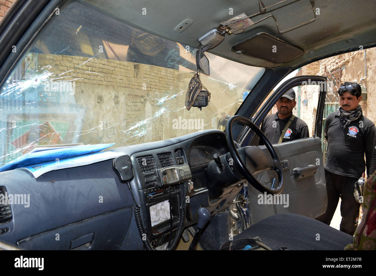 Quetta. 11th June, 2015. Police inspect a police van at the attack site ...