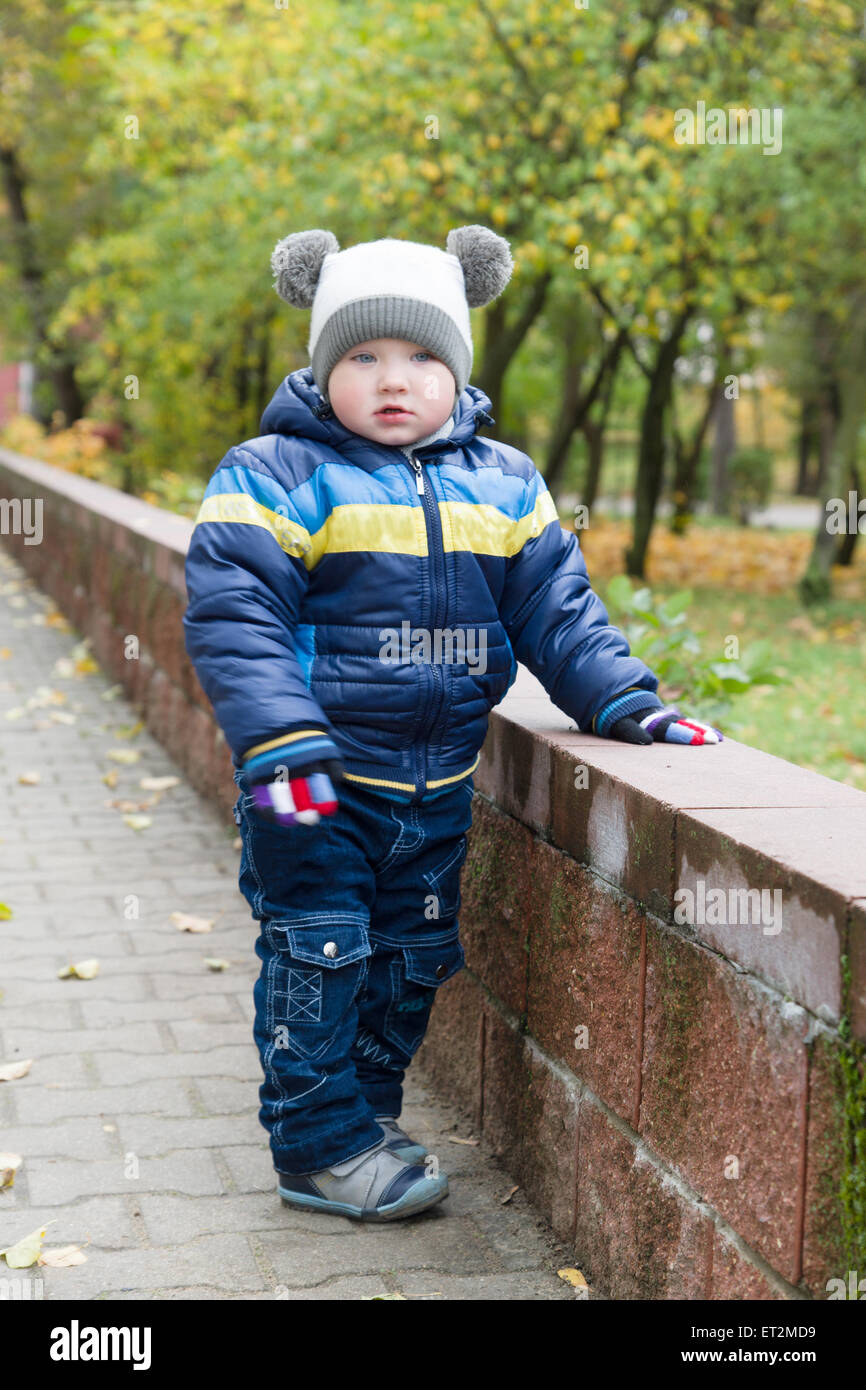 boy in jacket and cap fun walks in autumn park Stock Photo - Alamy