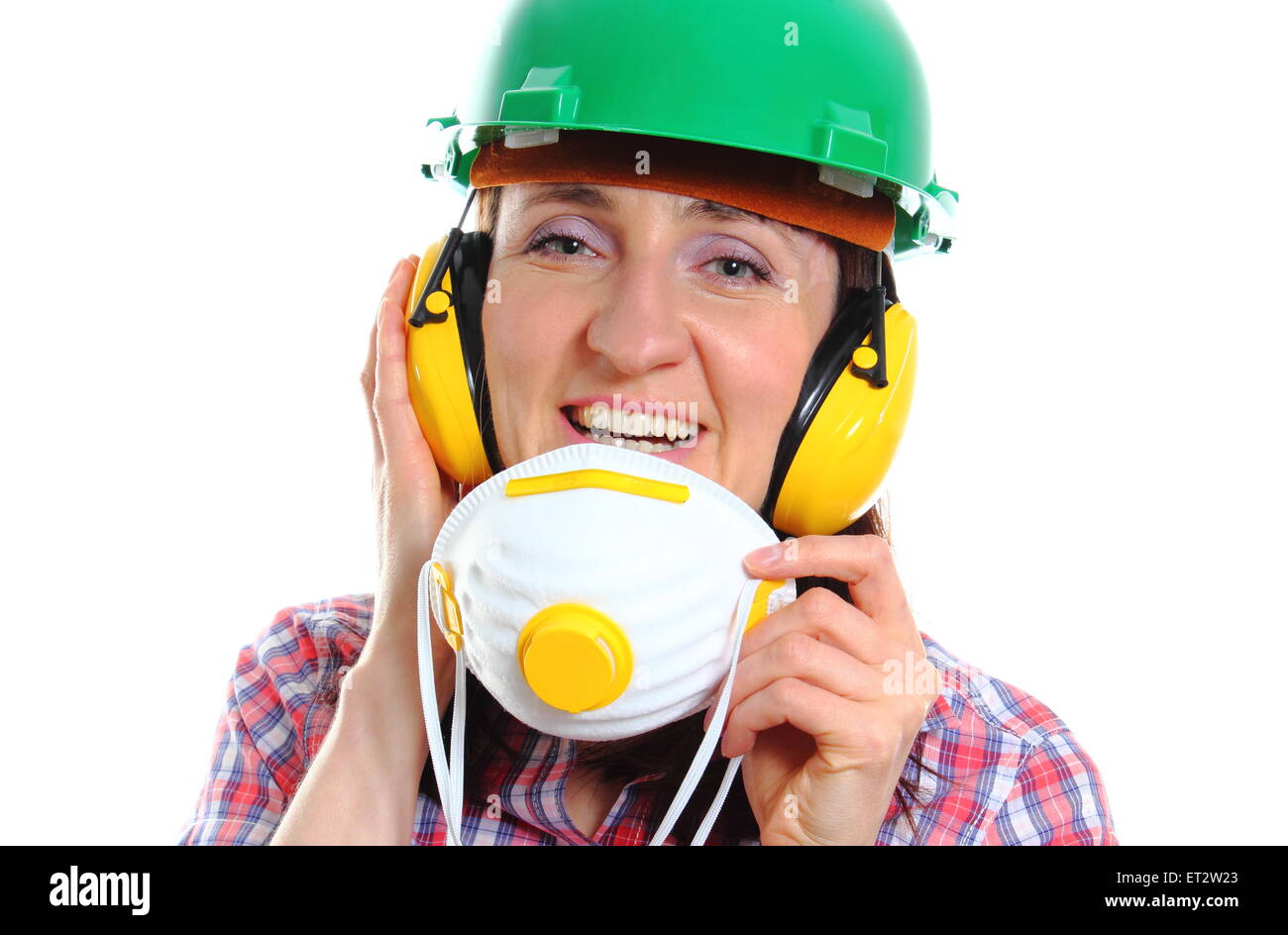 Smiling female construction worker with protective mask wearing green ...