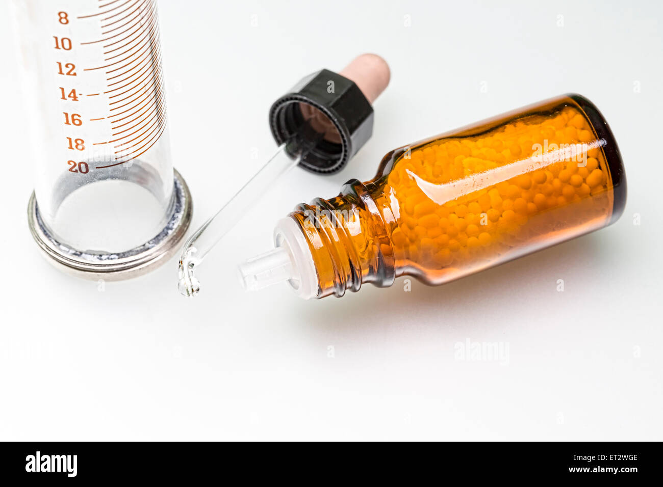 bottle with homeopathy globules, syringe and pipette Stock Photo - Alamy