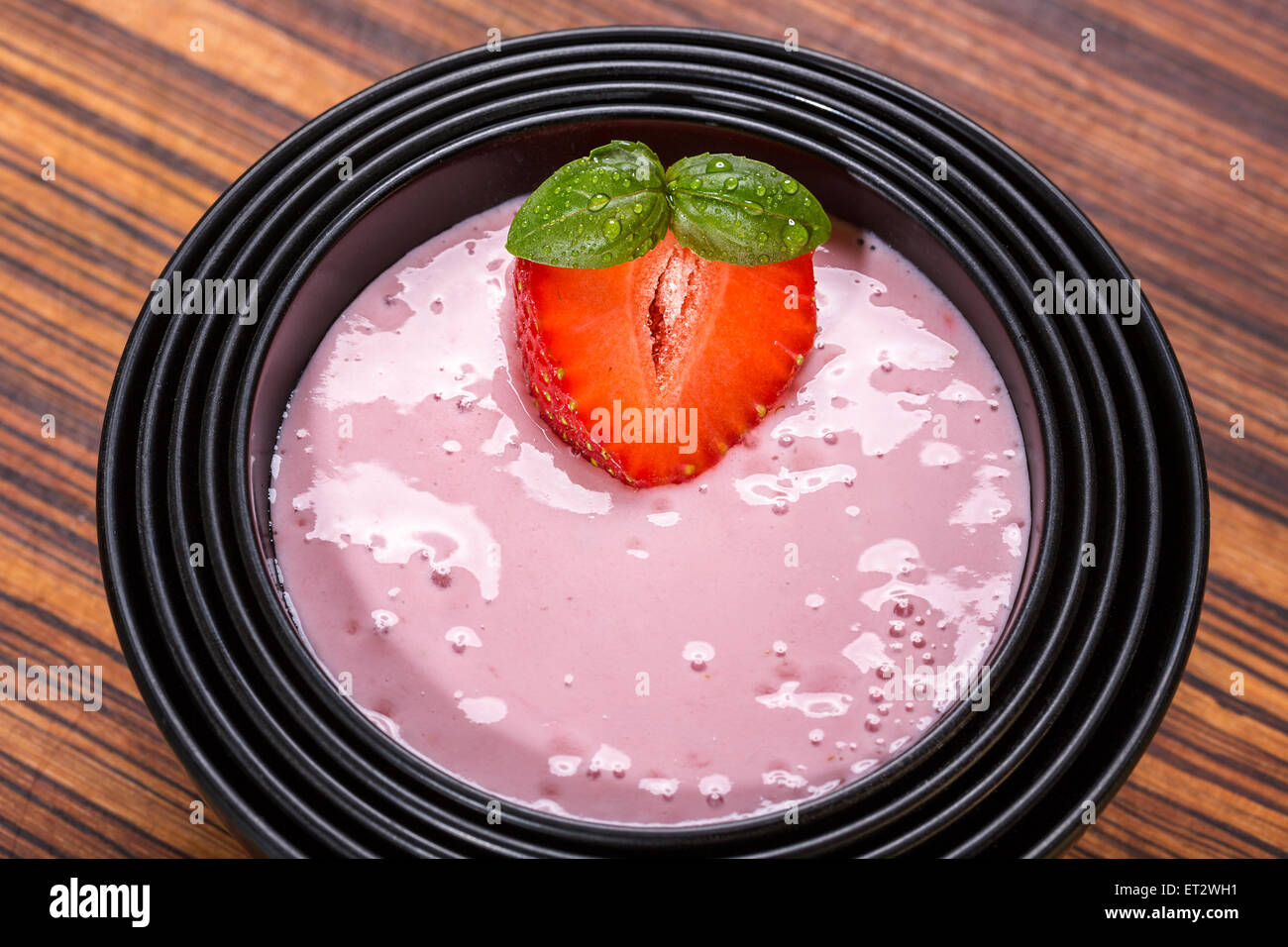 quark with strawberry in a black asian bowl Stock Photo - Alamy