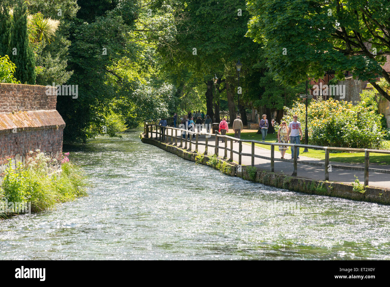 The River Itchen in Winchester in summer with people walking along the ...