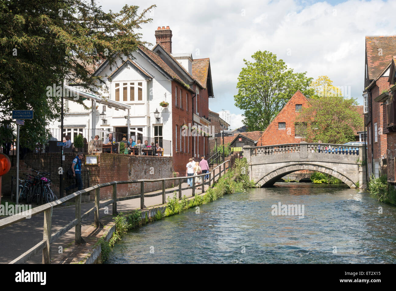 The River Itchen in Winchester UK in summer with people walking on the ...