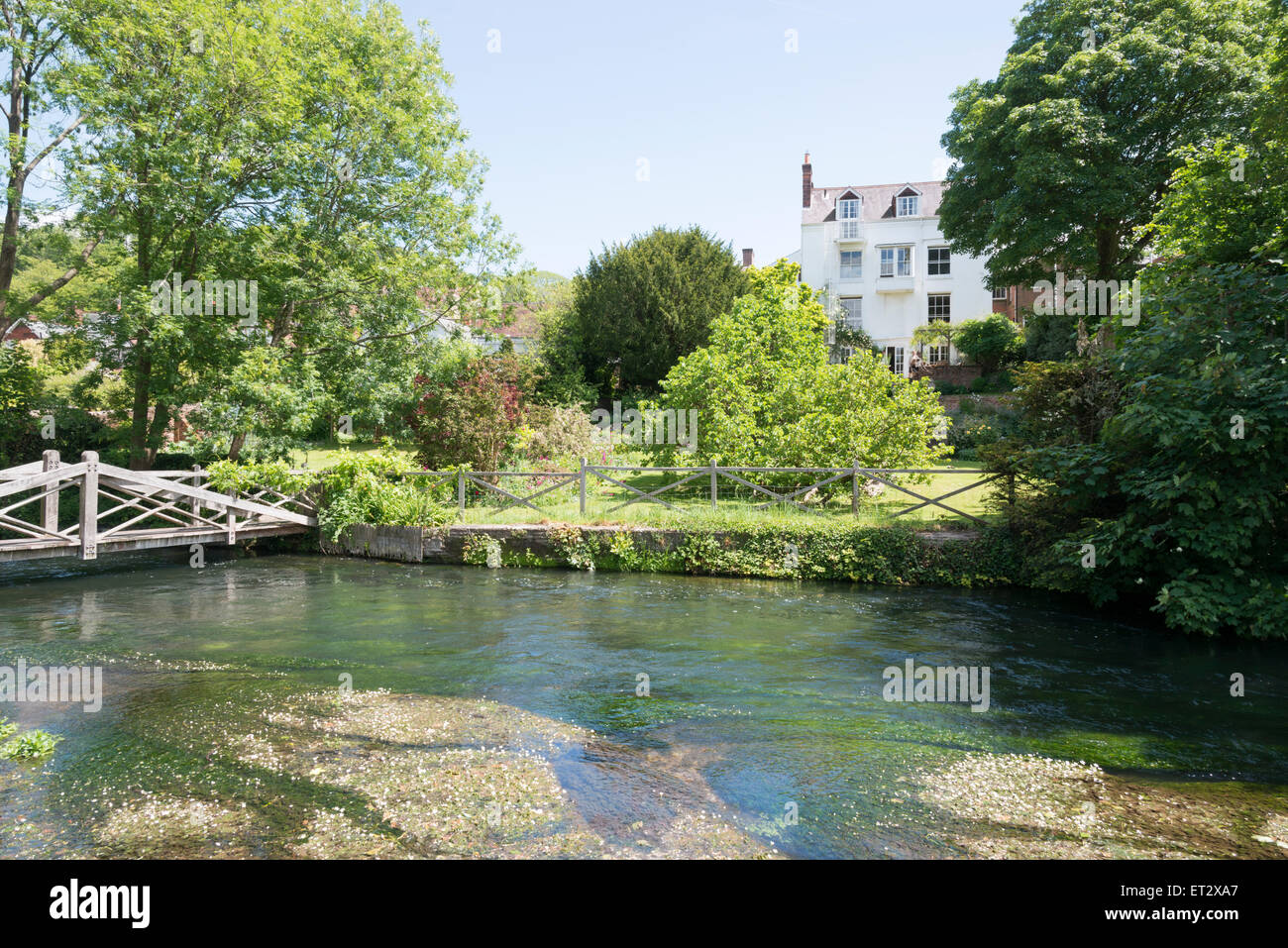 The River Itchen in Winchester UK in summer with people walking on the ...