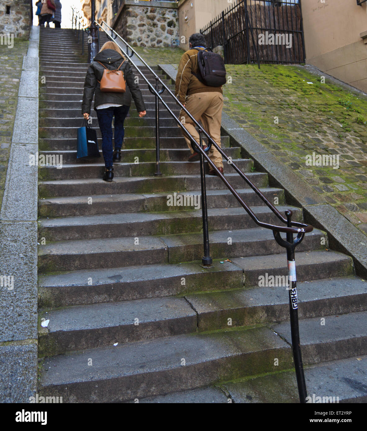 Two people climb steps in Montmartre Paris Stock Photo - Alamy