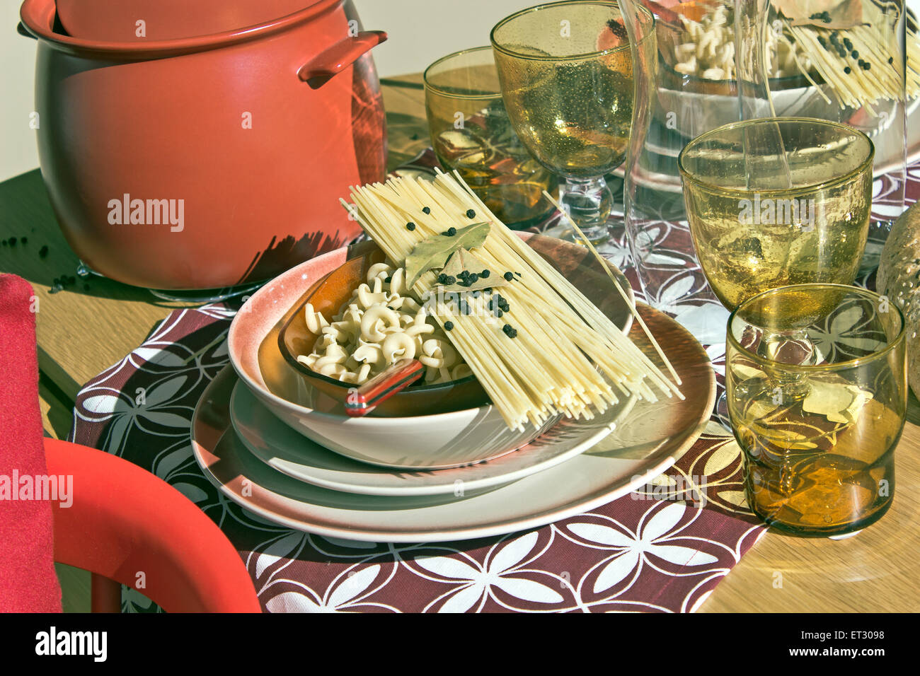 Table setting with dry spaghetti on plates Stock Photo - Alamy