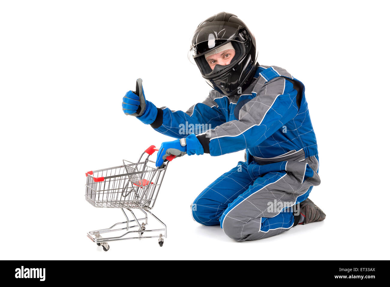 Racing driver posing with shopping cart isolated in white Stock Photo ...