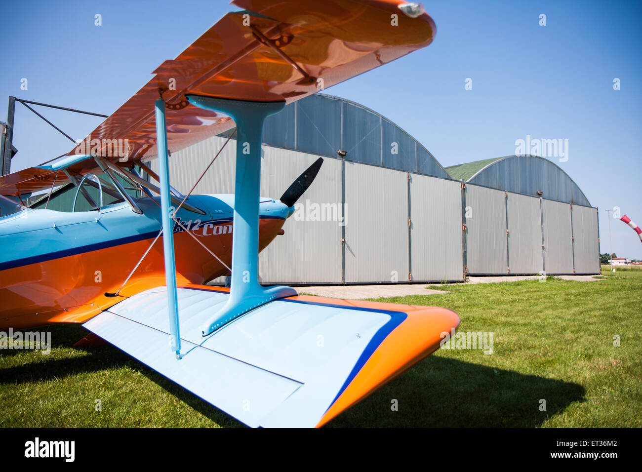 light aircraft, modern biplane orange and blue details and takeoff ...