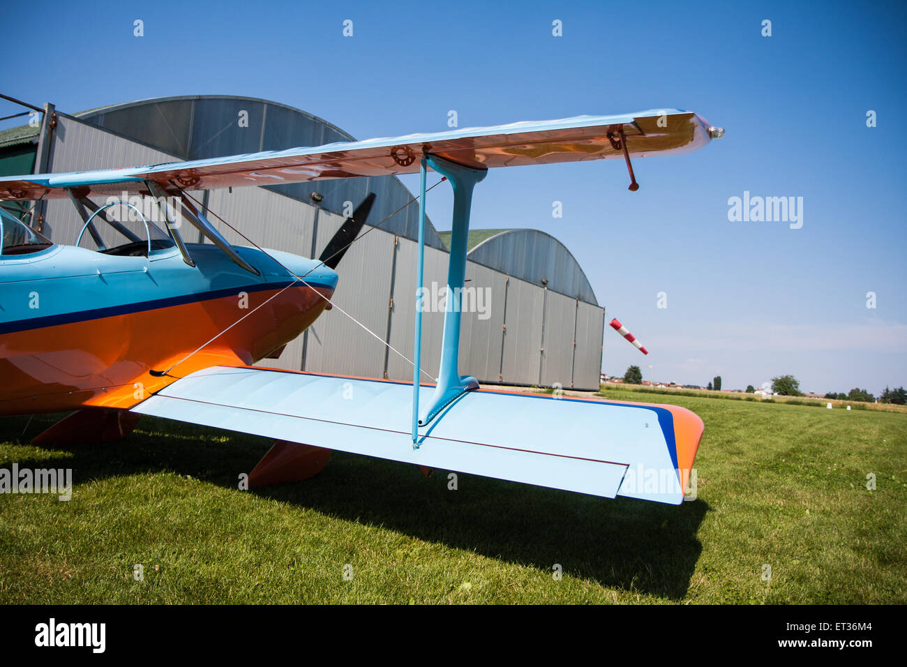 light aircraft, modern biplane orange and blue details and takeoff ...