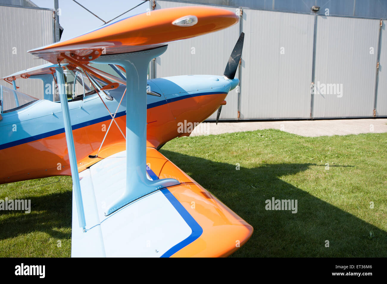 light aircraft, modern biplane orange and blue details and takeoff ...