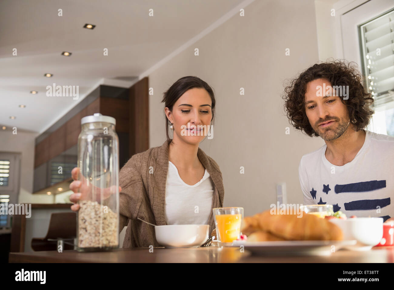 Mid adult couple having breakfast at dining table, Munich, Bavaria ...