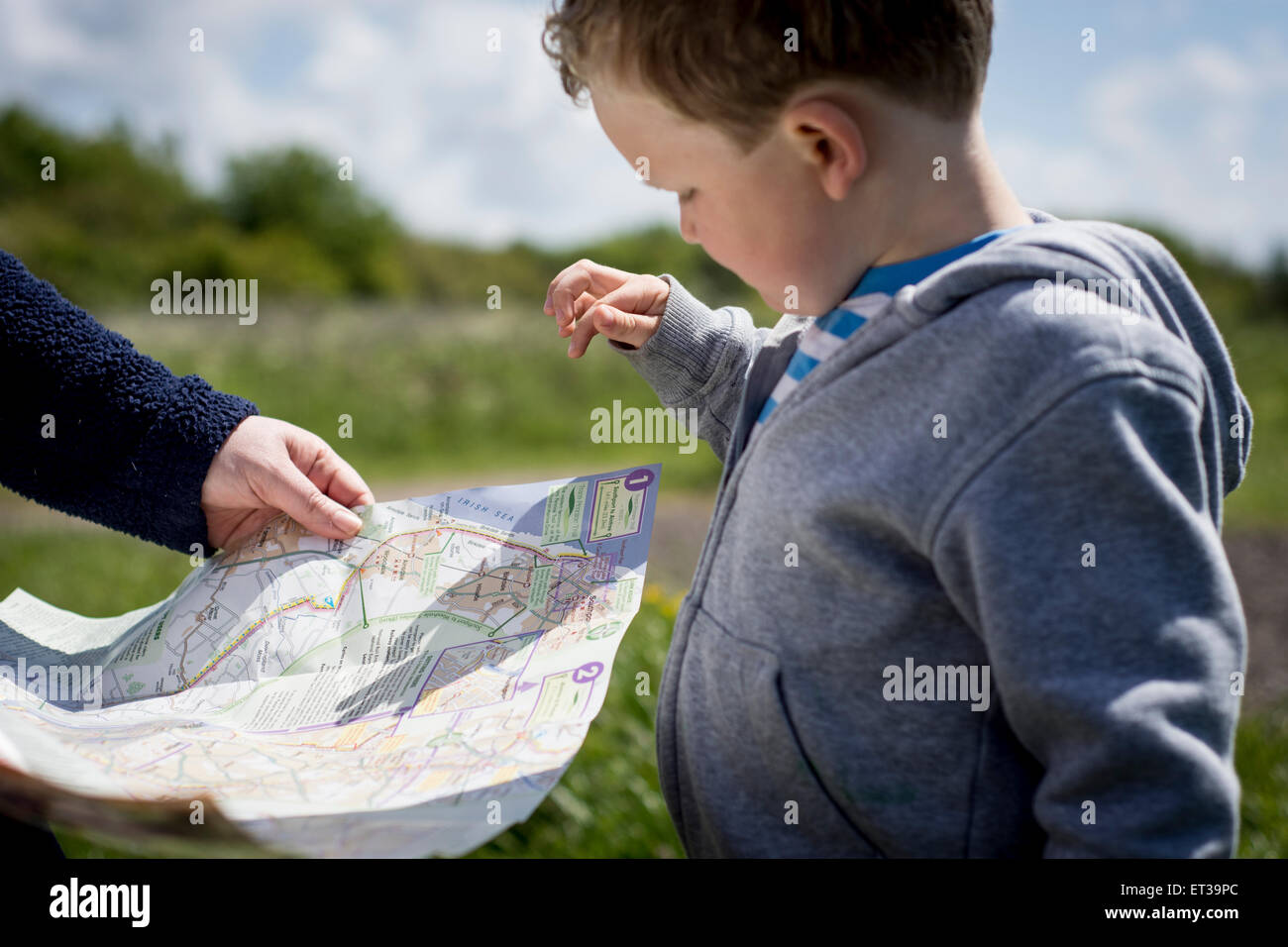 Mother and children boy girl family following a map walking in the ...
