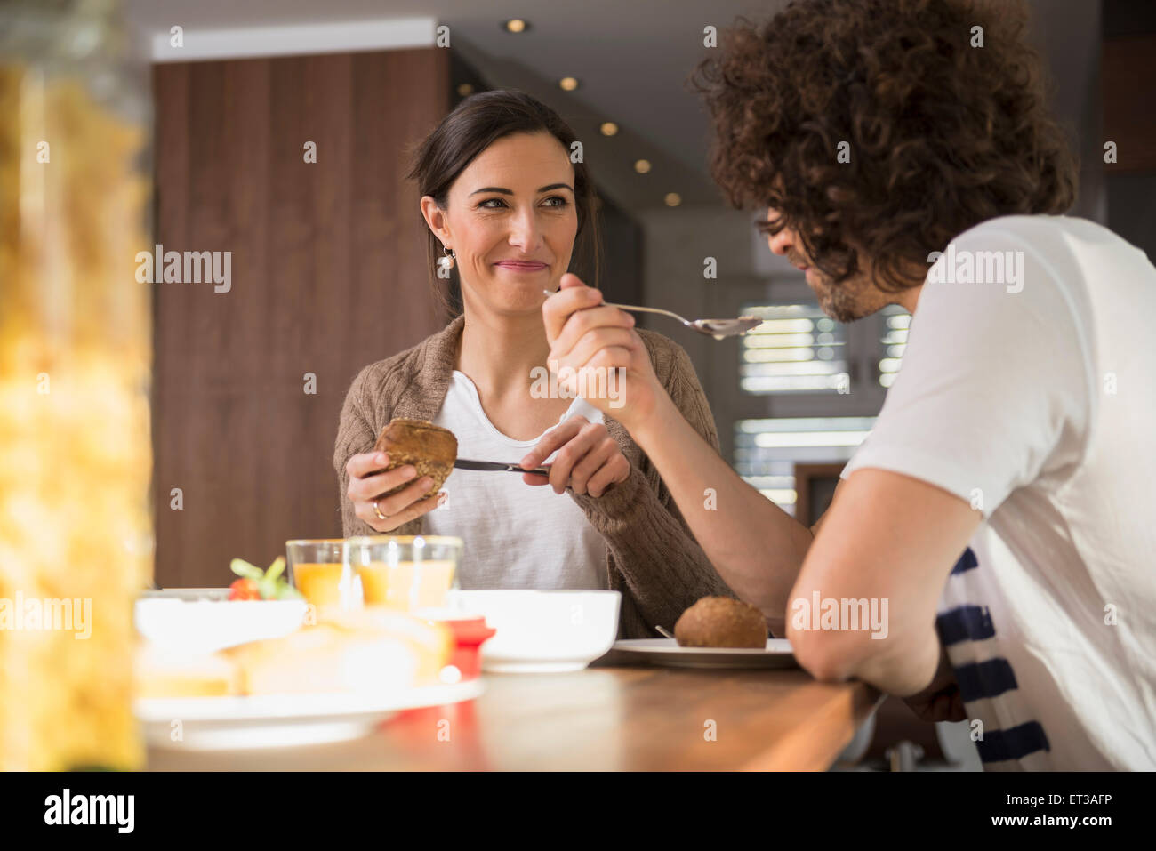 Mid adult couple having breakfast at dining table, Munich, Bavaria ...