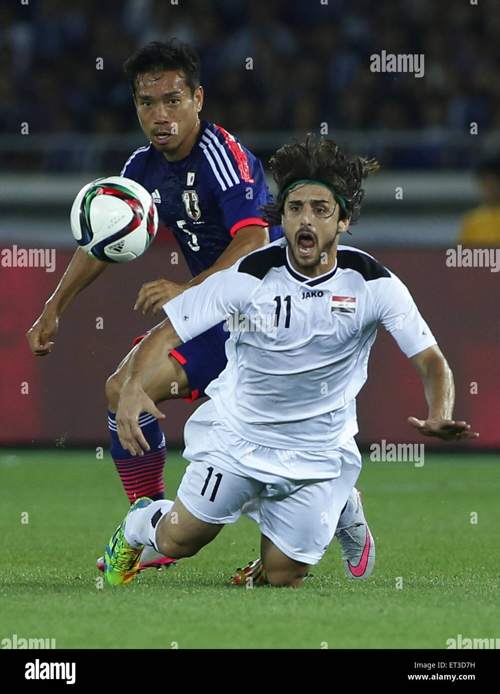 Yokohama, Japan. 11th June, 2015. Yuto Nagatomo of Japan (rear) and ...