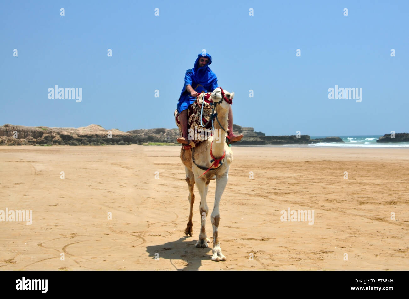 morocco berber riding camel on the atlantic ocean beach Stock Photo - Alamy