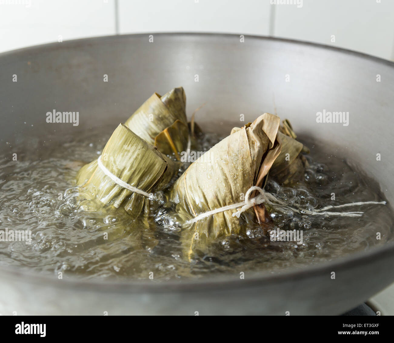 Zongzi boiling in a wok. Zhongzi is a traditional Chinese food eaten ...