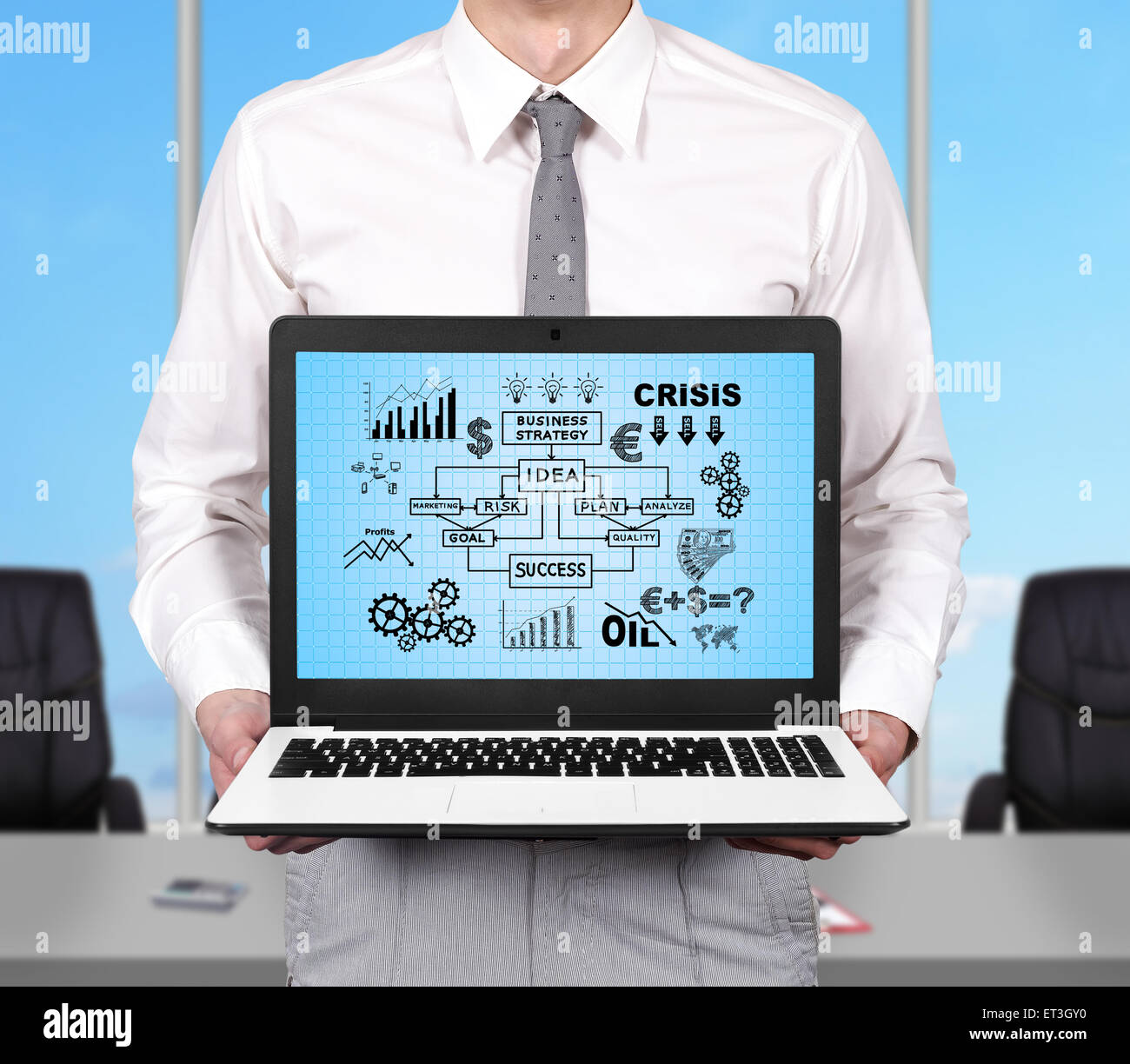 young businessman holding laptop with business strategy Stock Photo - Alamy