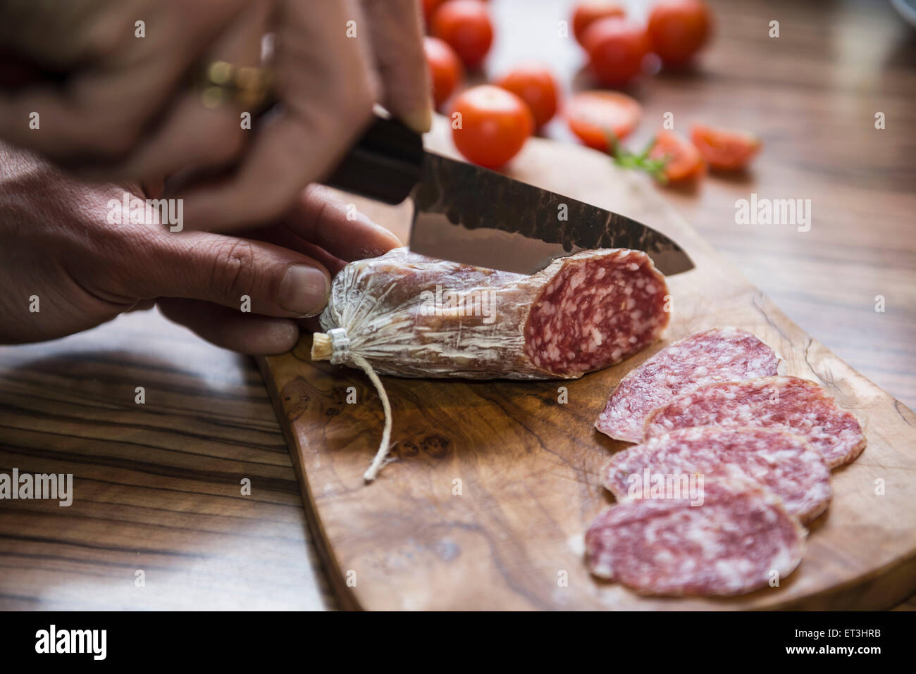Person's hand chopping sausage with knife, Germany Stock Photo - Alamy