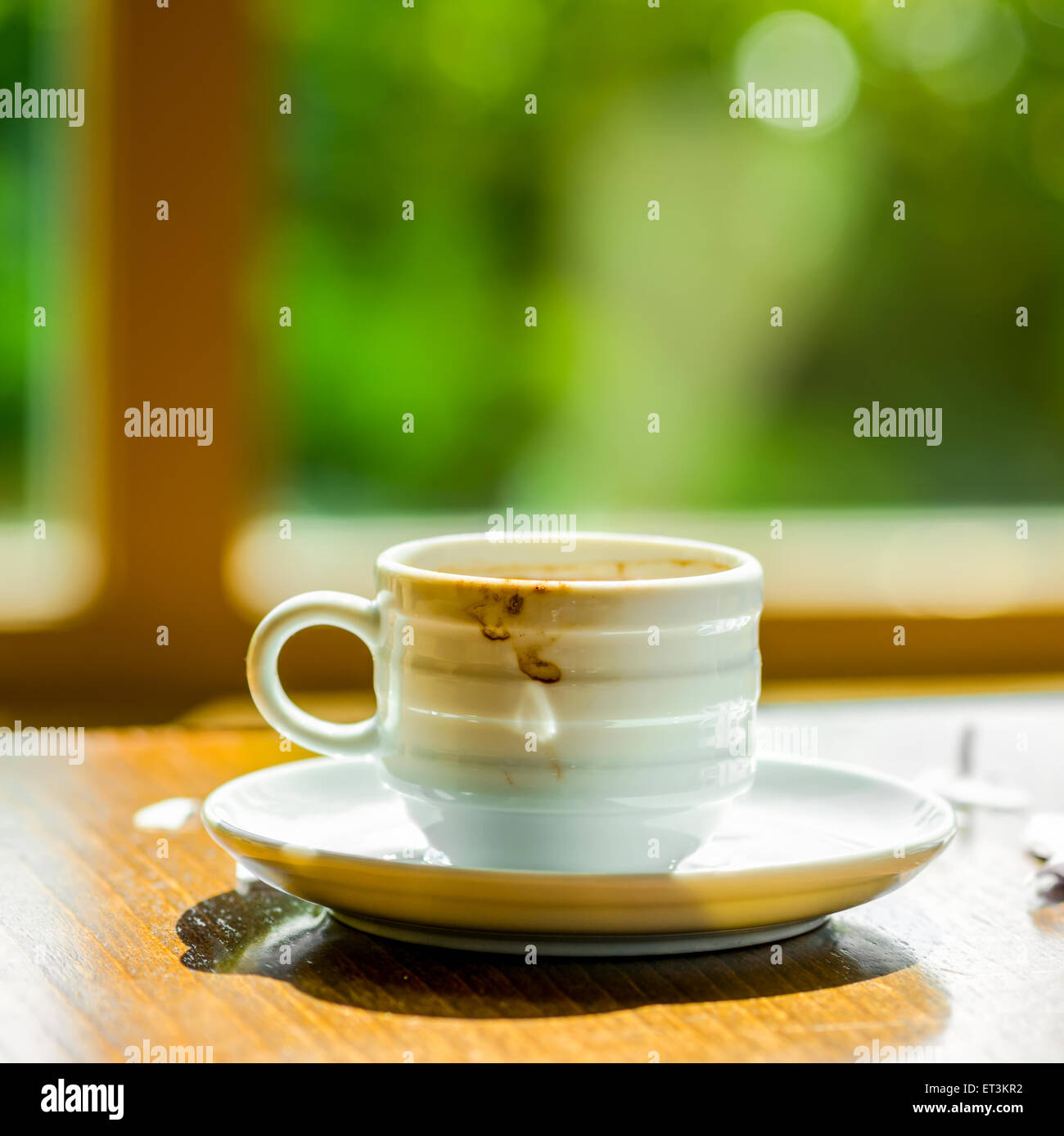 concept of cup coffee drunk and torn paper near the window in the ...