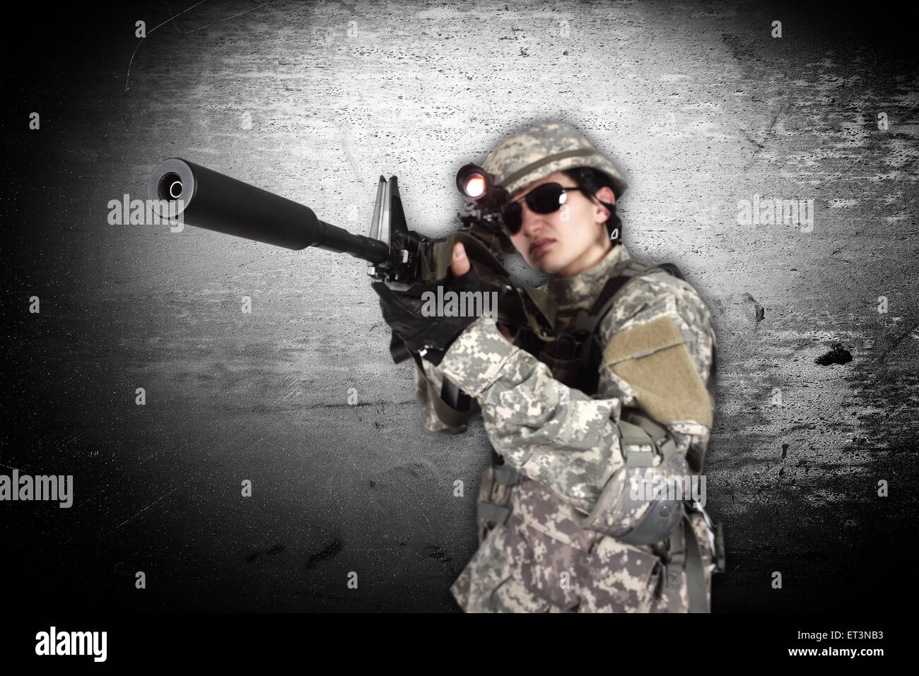 soldier holding his assault rifle isolation on gray Stock Photo - Alamy