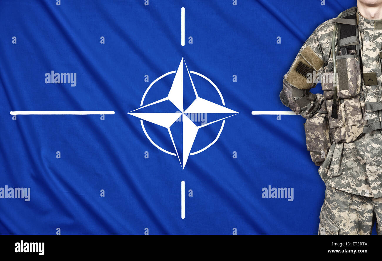 US soldier on a Nato flag background Stock Photo - Alamy