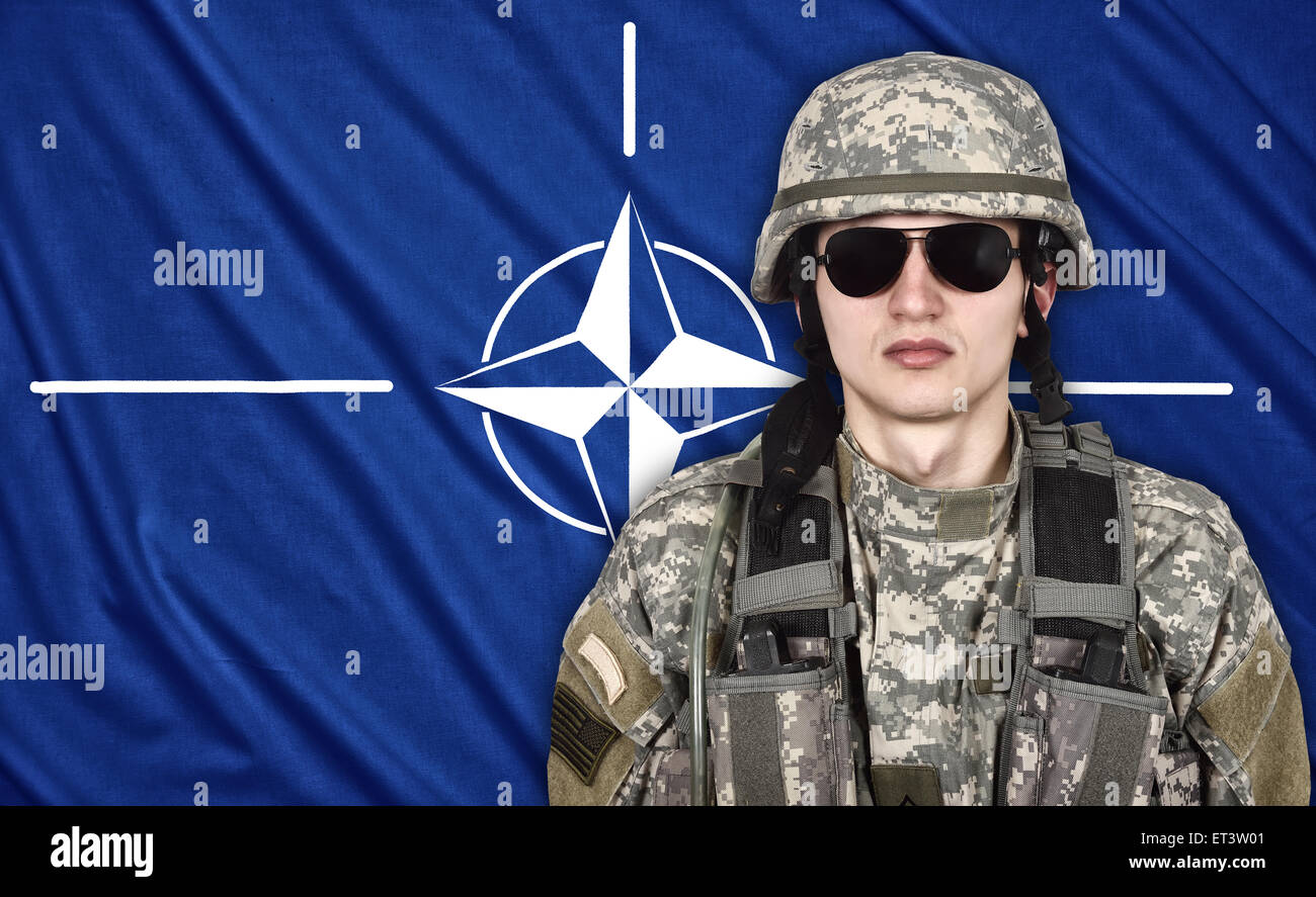 american soldier and Nato flag on background Stock Photo - Alamy
