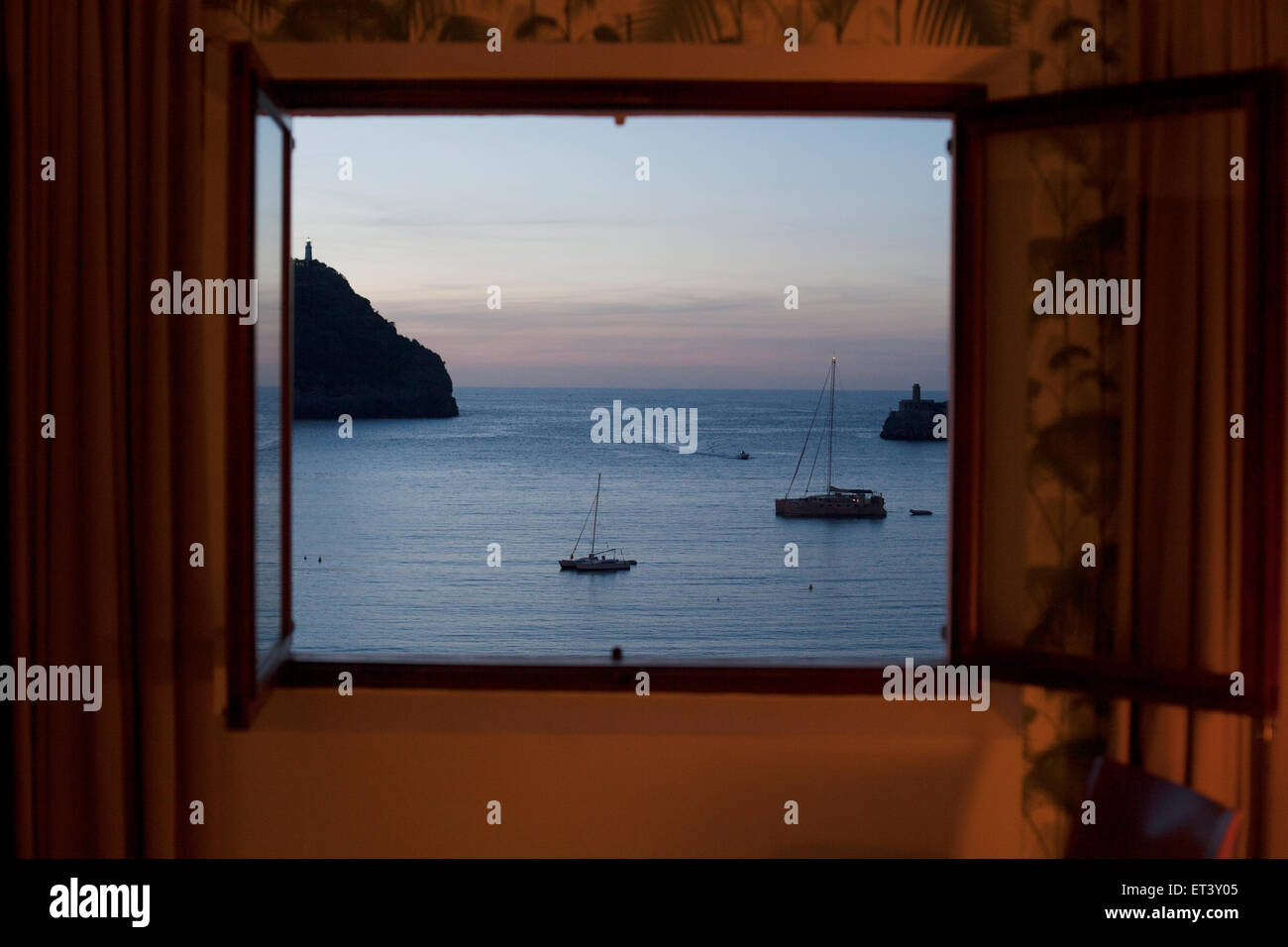Sunset on a port through a hotel window Stock Photo - Alamy