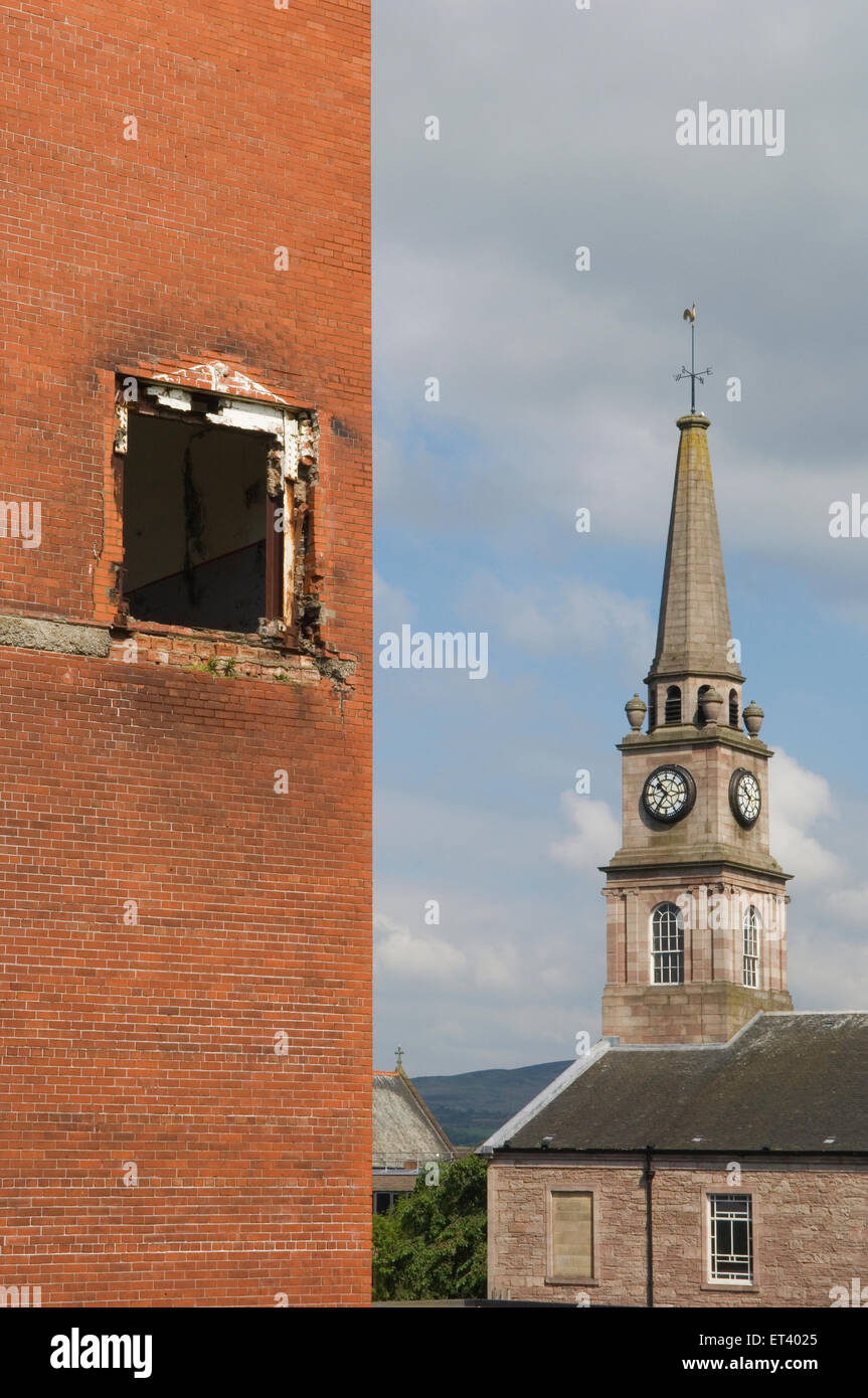 The ruin of Dumbarton Distillery with the spire of Dumbarton Riverside ...