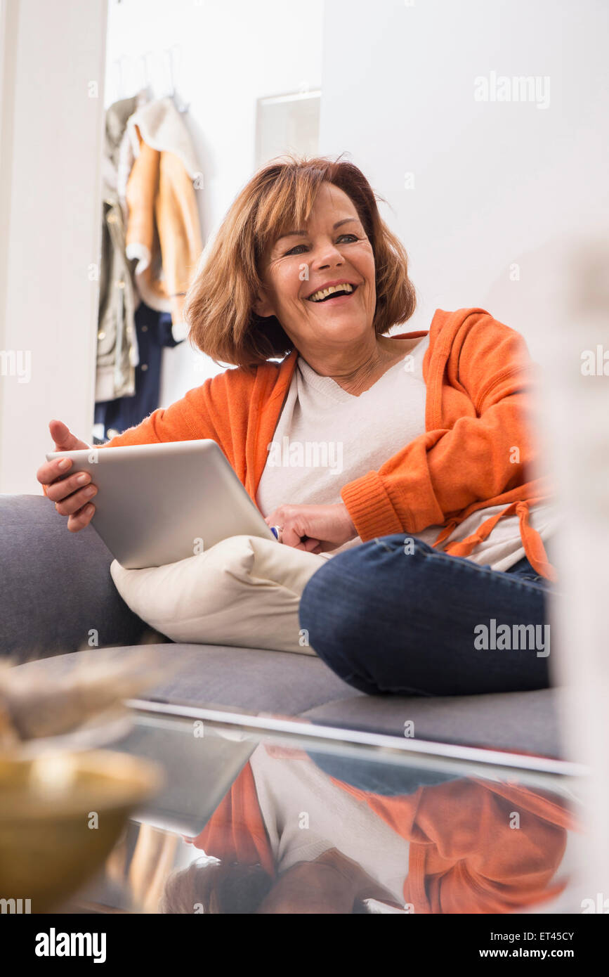Happy senior woman working a digital tablet, Munich, Bavaria, Germany ...