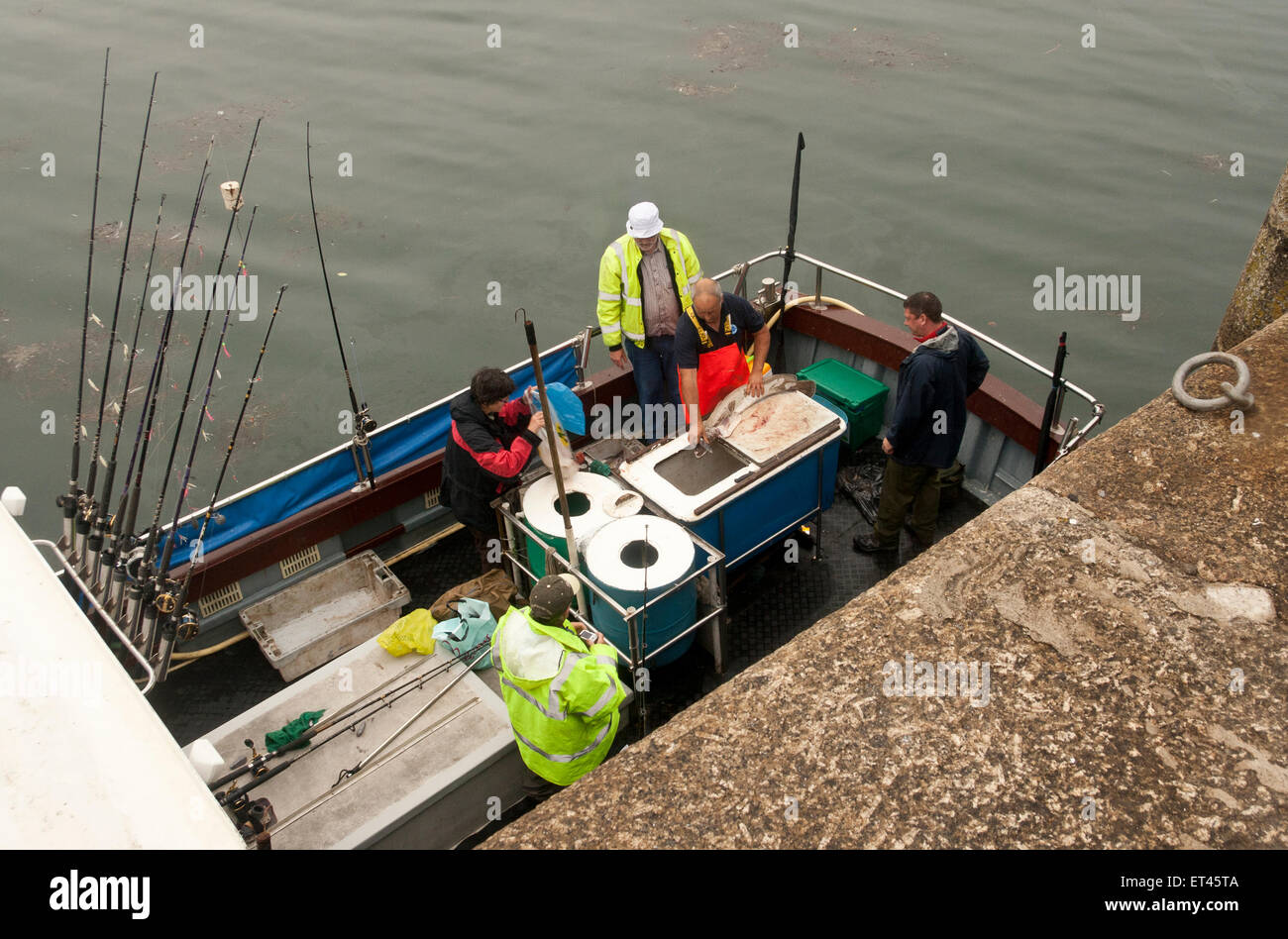 Fishing boat returning to a working harbor after a fishing trip at ...