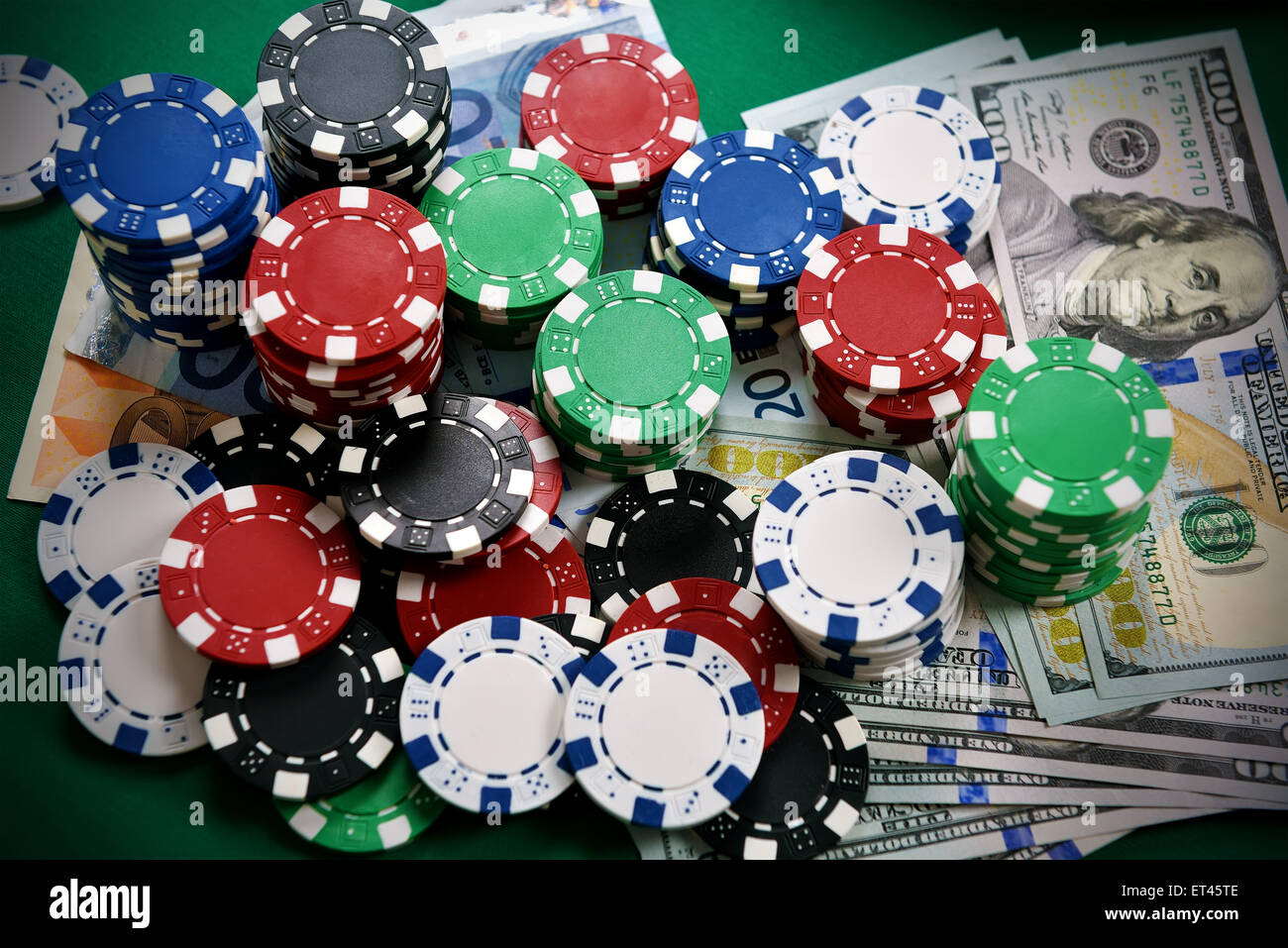 Stack of color poker chips and money Stock Photo - Alamy