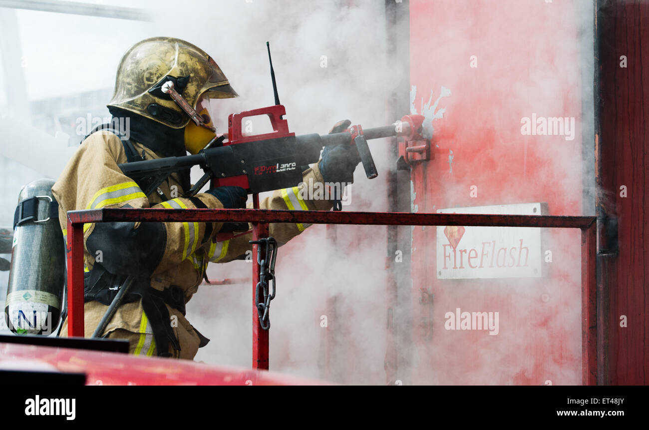 A fire fighter uses a so-called 'Pyrolance' to extinguish a fire in a ...