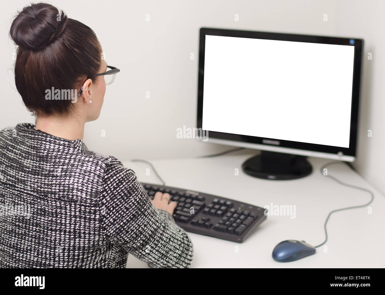 woman typing and sleeping on a computer at a desk in the office with a ...