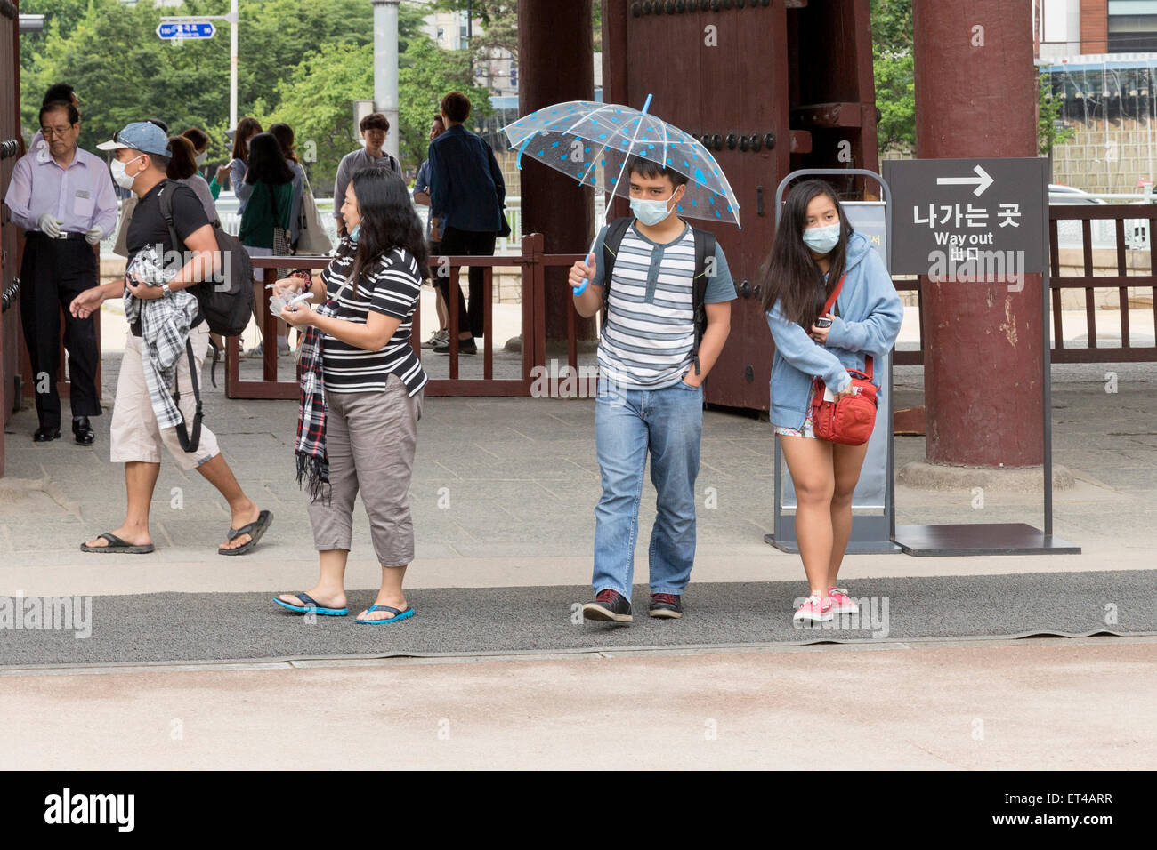 Tourists, wearing face masks as a precaution against the MERS, Middle ...