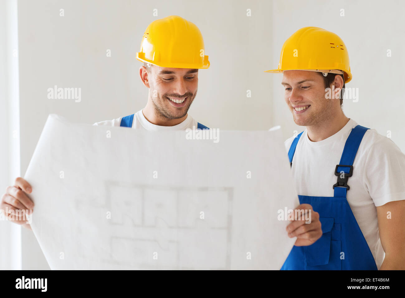 group of builders with blueprint Stock Photo - Alamy
