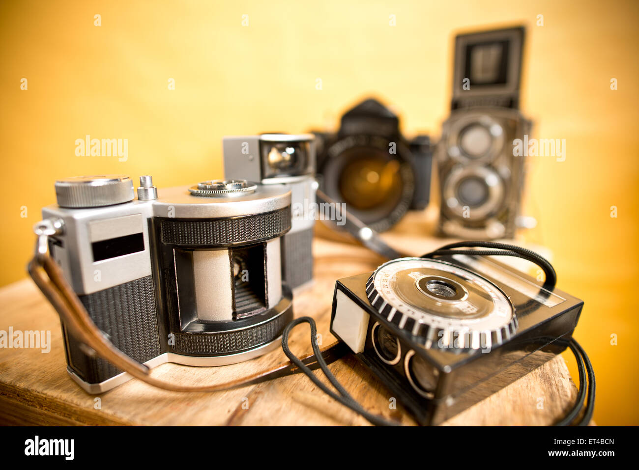 old analogue photographic cameras on the yellow Stock Photo - Alamy
