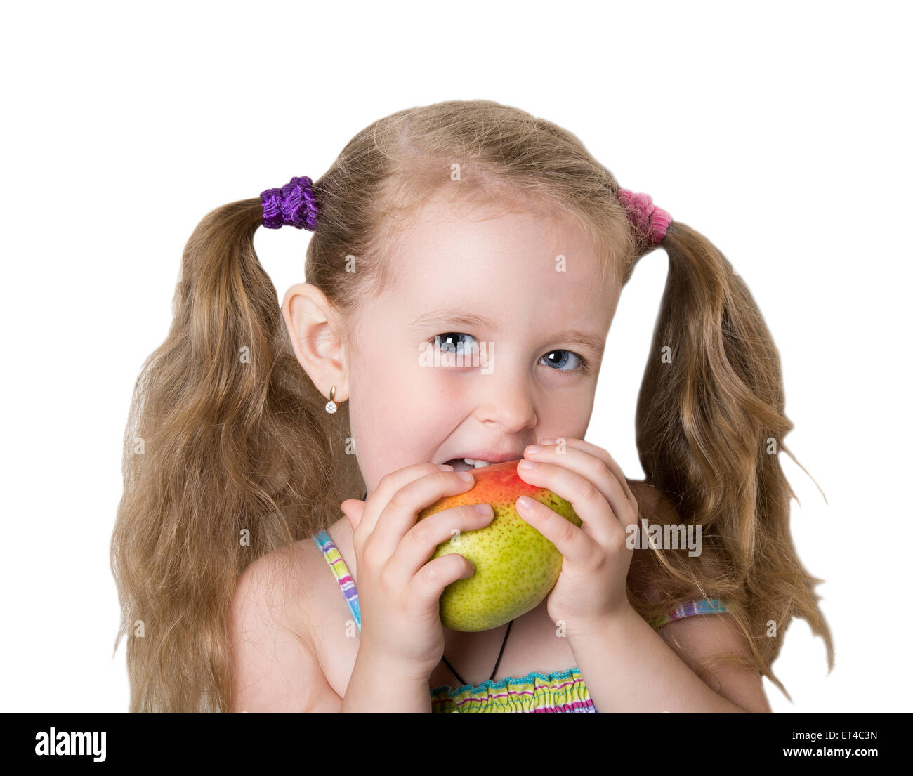 little girl biting pear Stock Photo - Alamy