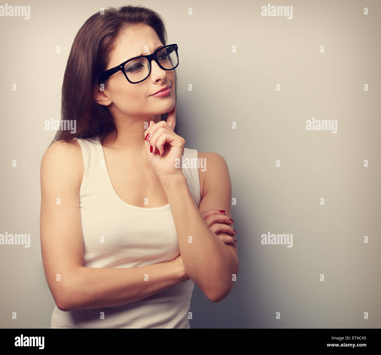 Thinking serious young woman in glasses looking. Vintage closeup ...
