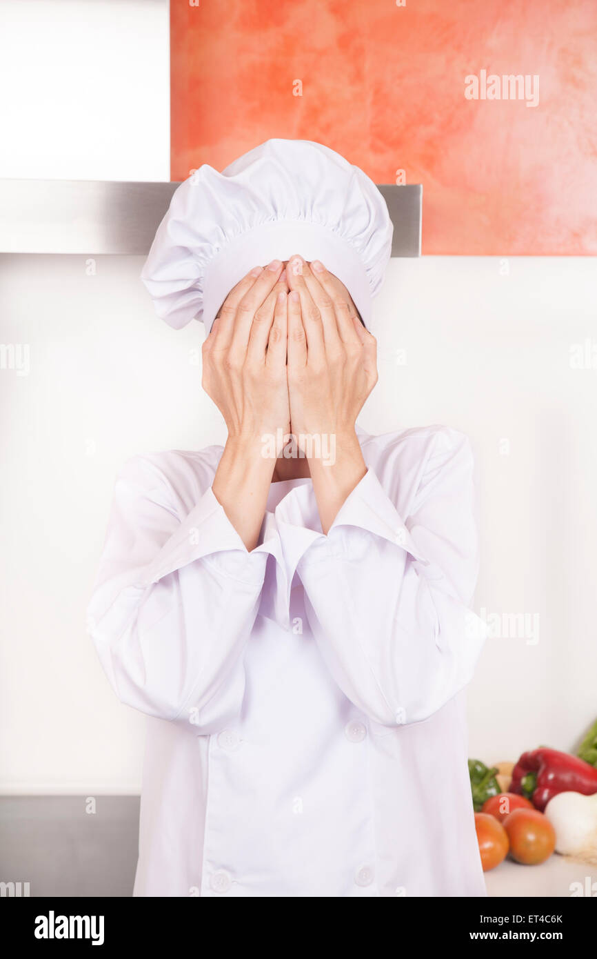 portrait of brunette chef woman with professional jacket and hat in ...