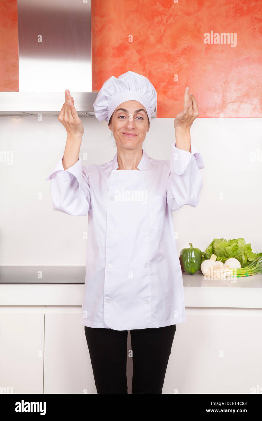 portrait of brunette happy chef woman with professional jacket and hat ...