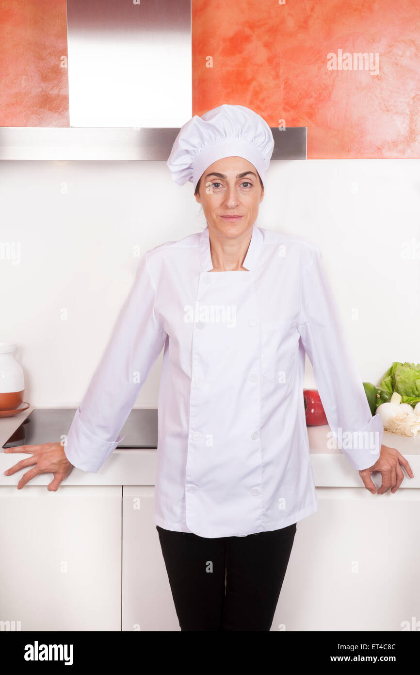 portrait of brunette chef woman with professional jacket and hat black ...