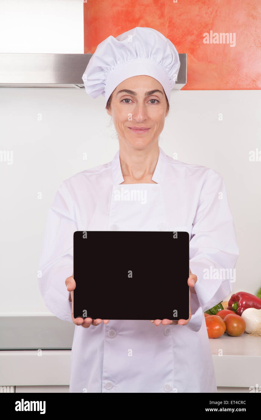 portrait of brunette happy chef woman with professional jacket and hat ...