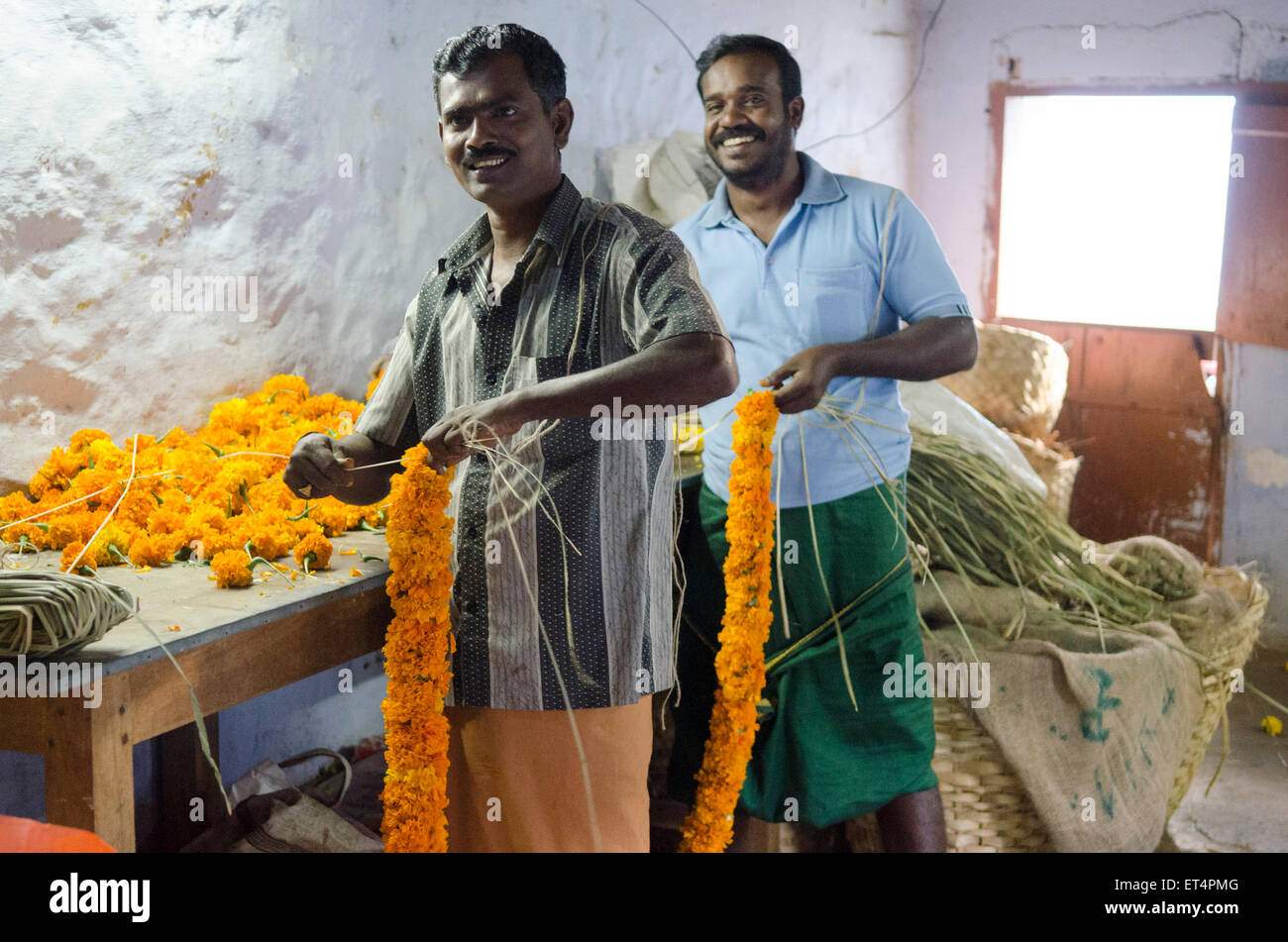 men make large flower garlands at Thovalai flower market Stock Photo ...