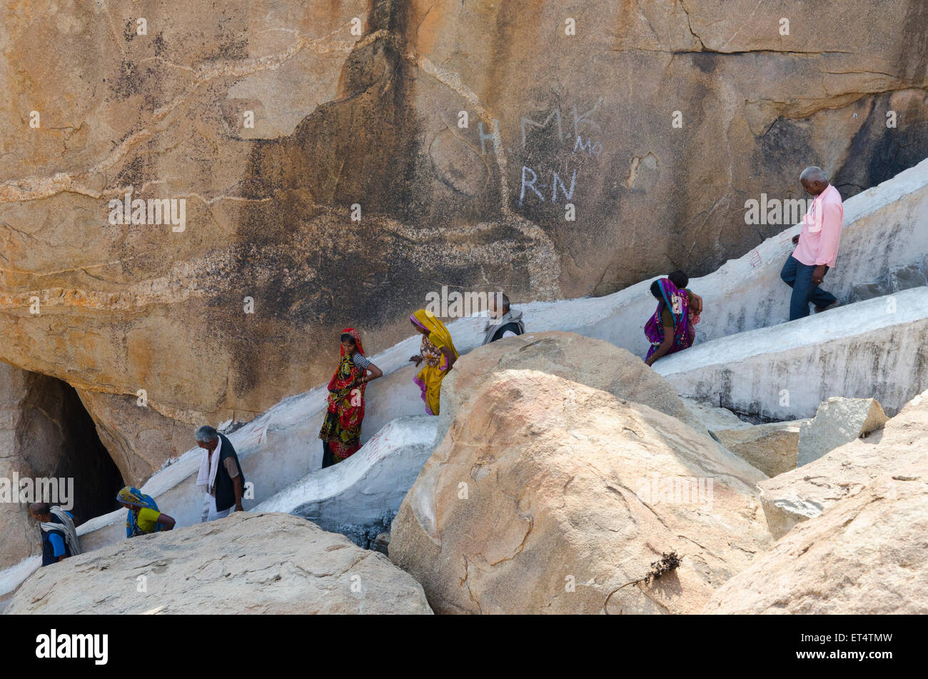 Indian men and women descend a mountain staircase in the ancient city ...